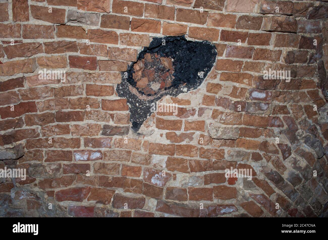Hole with coal in the brick wall Stock Photo - Alamy
