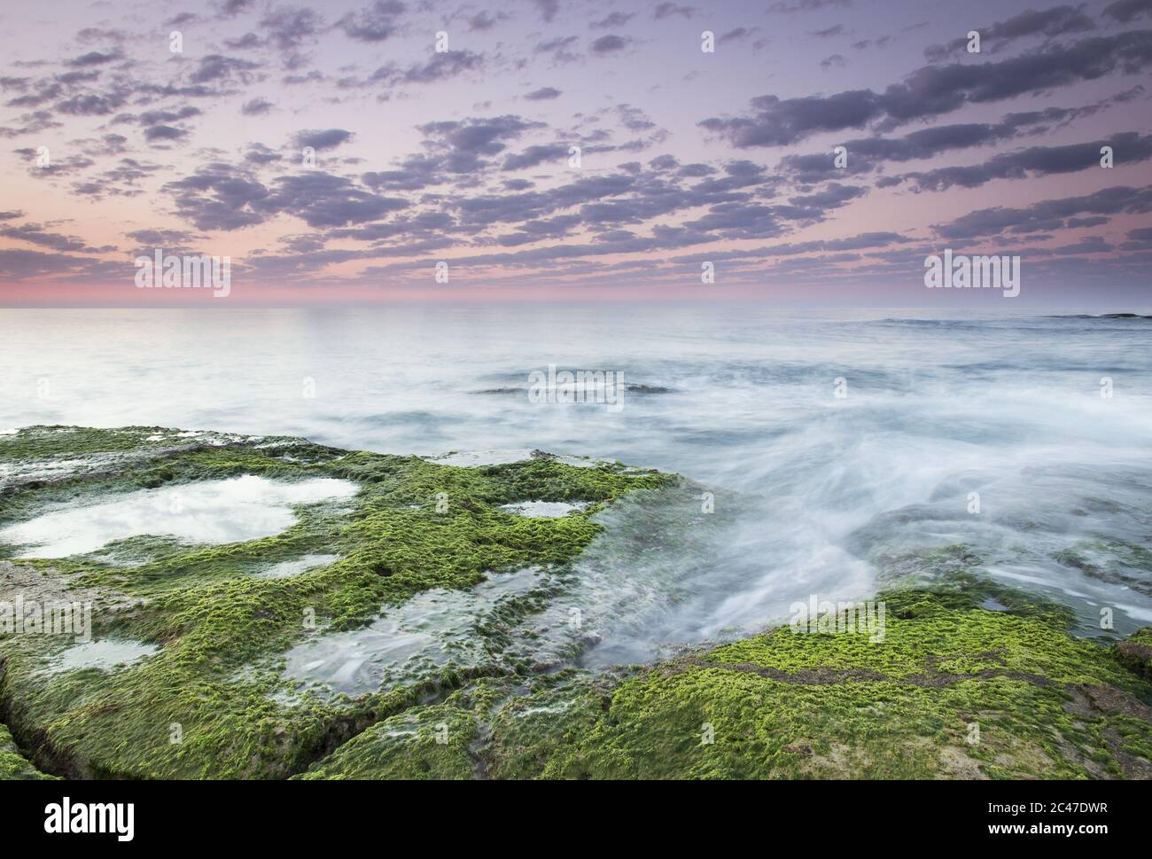 Beautiful scenery of a powerful waterfall with rock formations covered ...