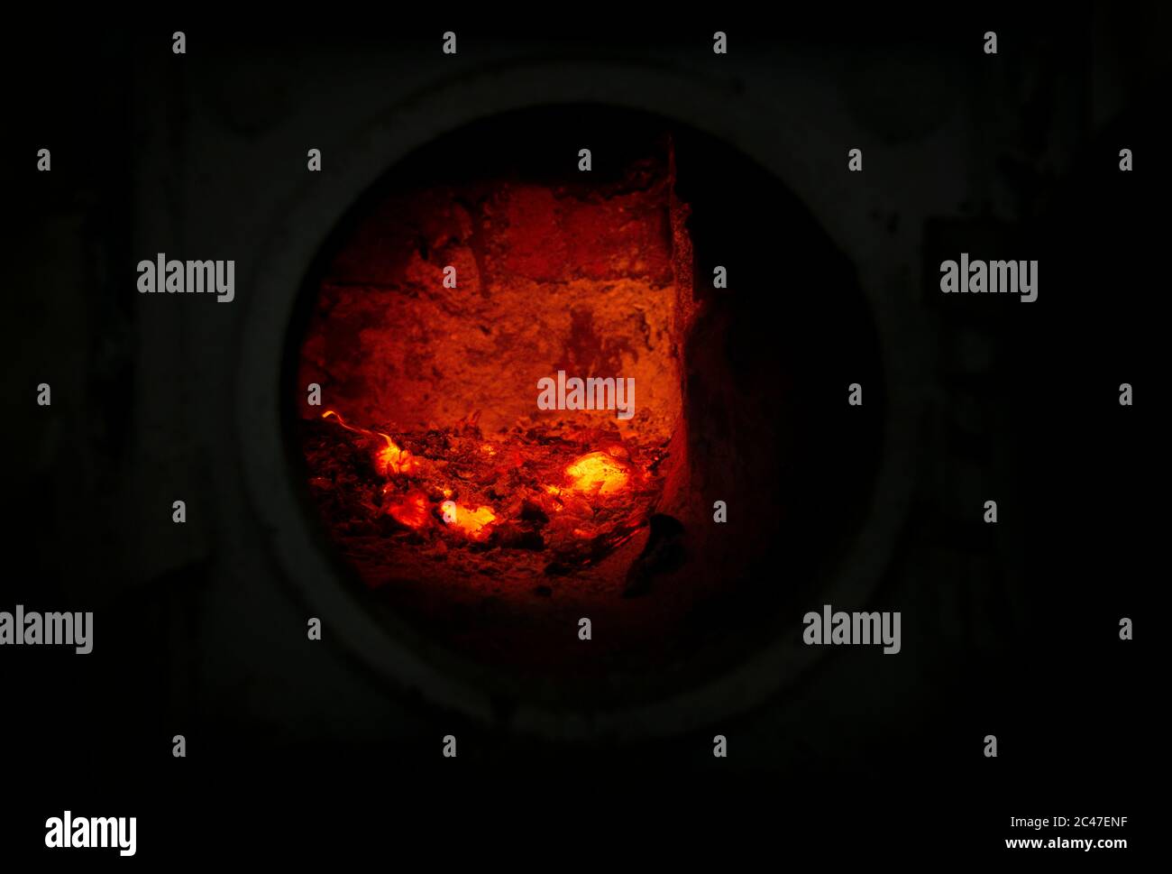 brick furnace with fire and ember, round door Stock Photo - Alamy