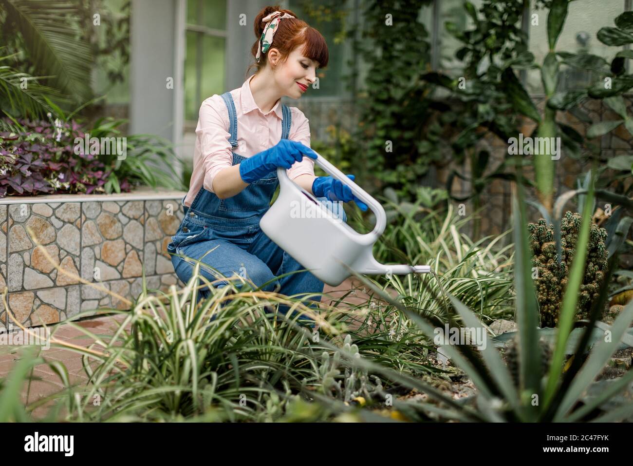 Portrait of pretty female botanist, the gardener who working with the ...