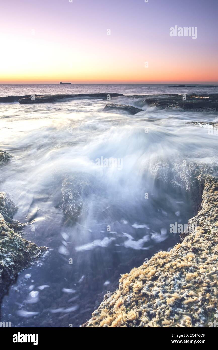 Beautiful scenery of waterfall in the sea with rock formations at ...