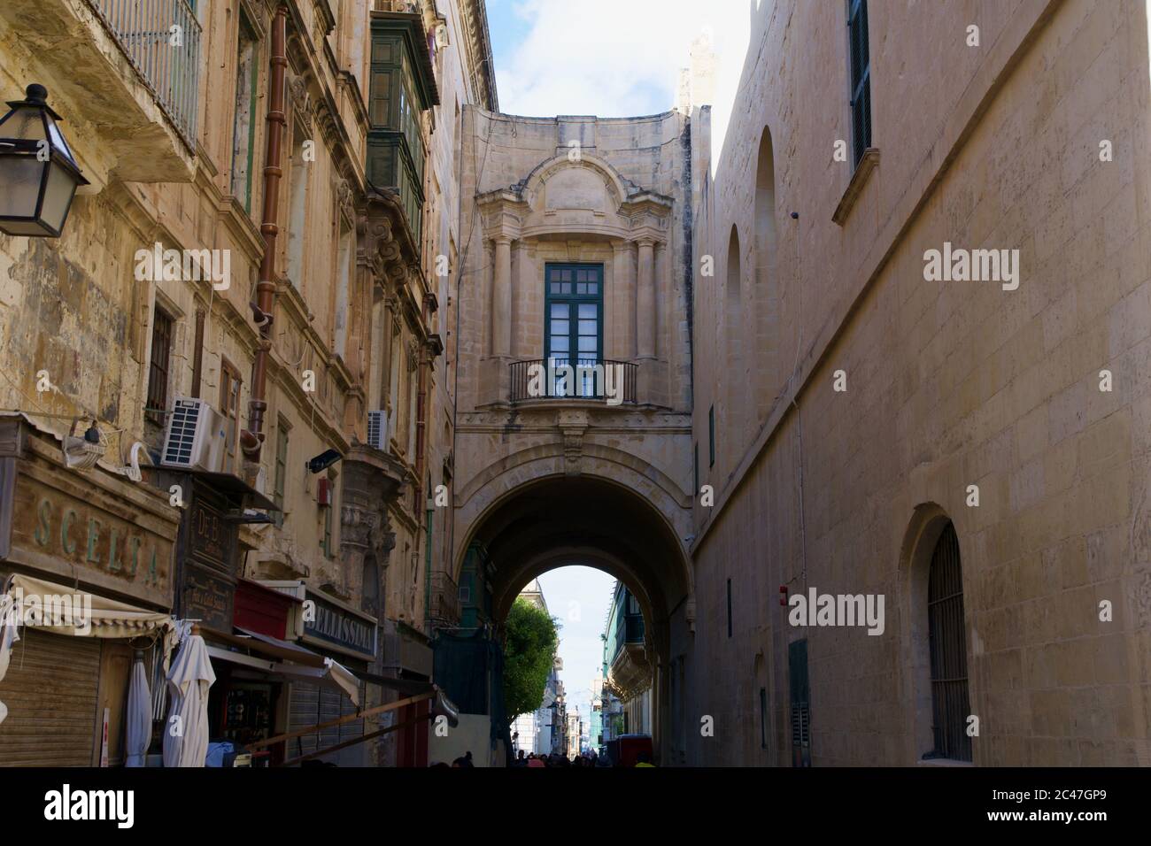 VALLETTA, MALTA - DEC 31st, 2019: Typical narrow cozy street in ... VALLETTA, MALTA - DEC 31st, 2019: Typical narrow cozy street in ...