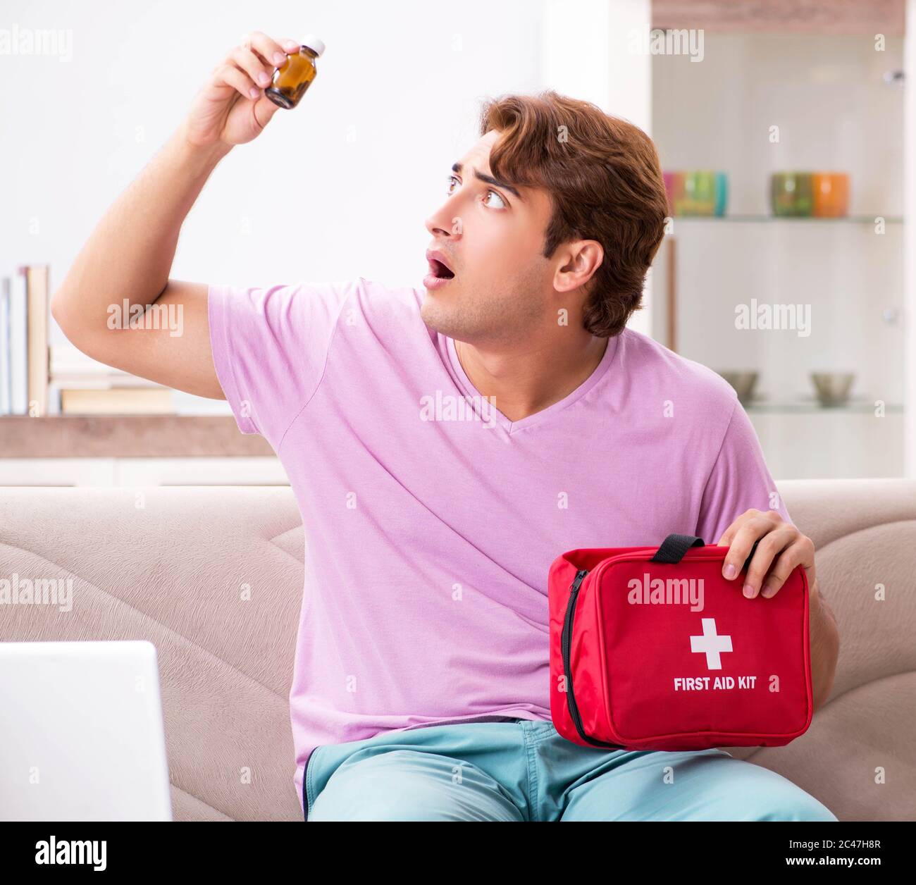 The sick man at home with first aid kit Stock Photo - Alamy