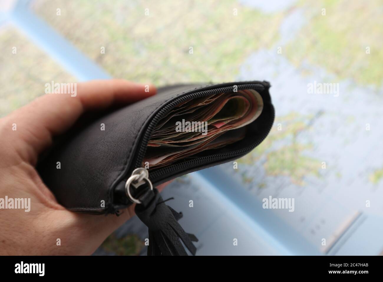 Hand holding money. Offshore investments concept Stock Photo - Alamy