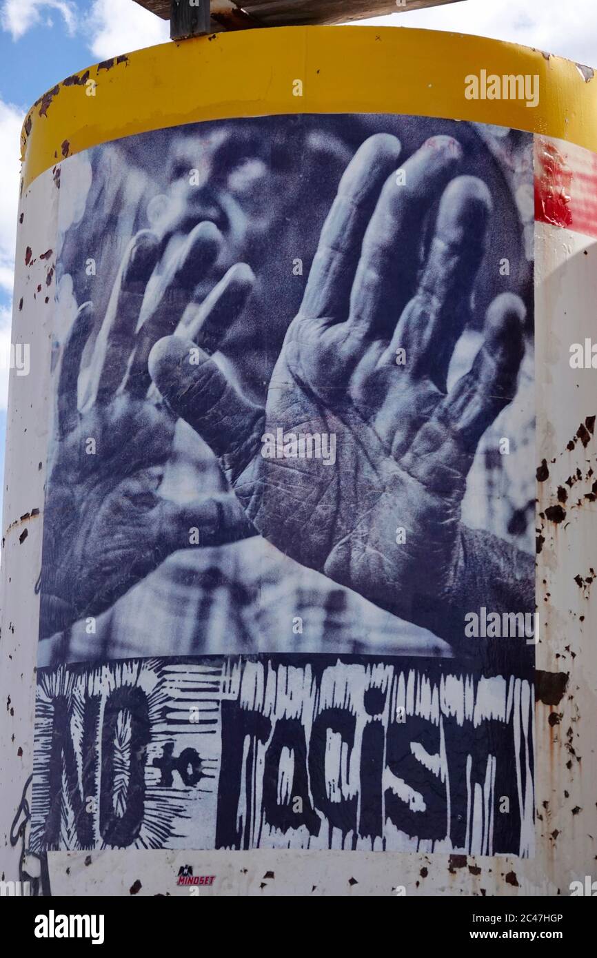 On an abandoned wall a worn mural requesting to say no to racism with a ...