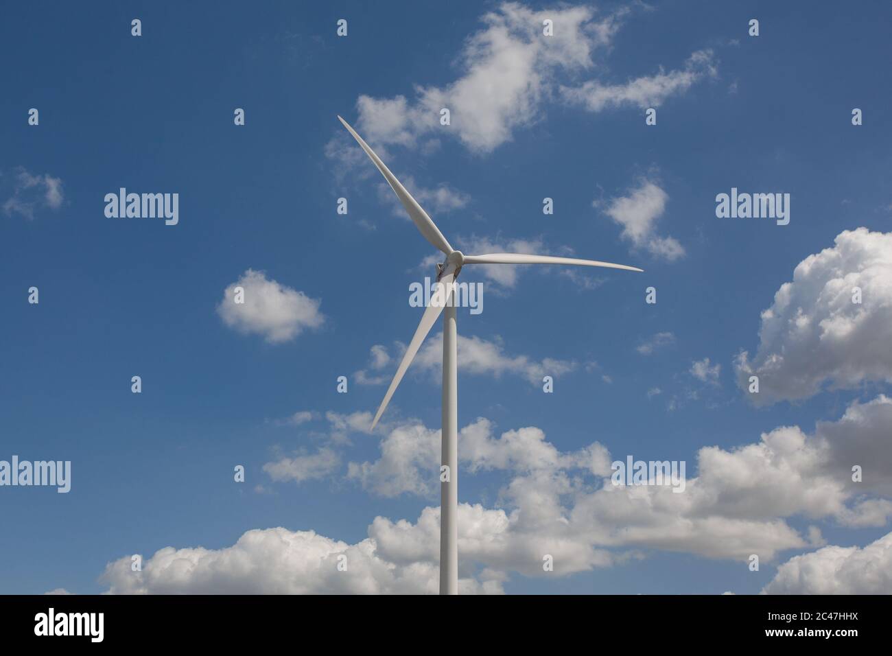 Low angle shot of a windmill under the sunlight and a blue sky at ...