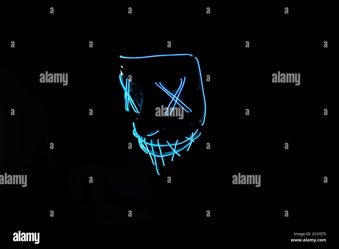 Man with blue led mask for partying Stock Photo - Alamy