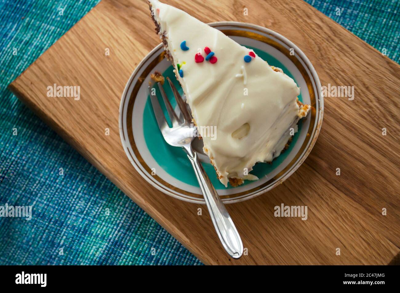 A piece of chocolate sponge cake with cream on a saucer close up ...