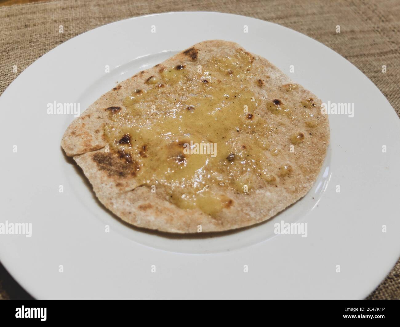 Indian homemade chapati with ghee. Chapati is a flat bread from India ...