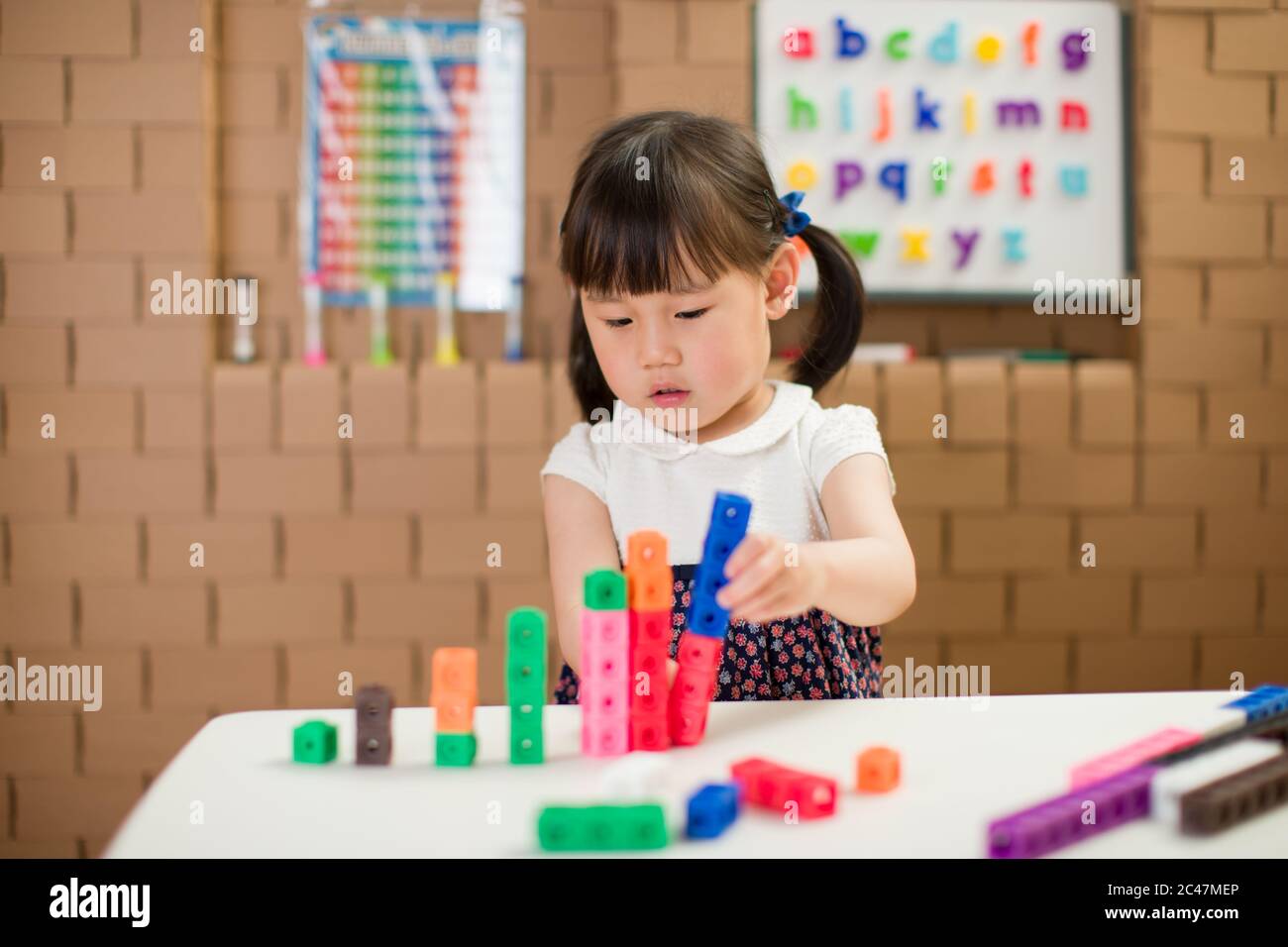 toddler girl play number blocks for homeschooling Stock Photo - Alamy