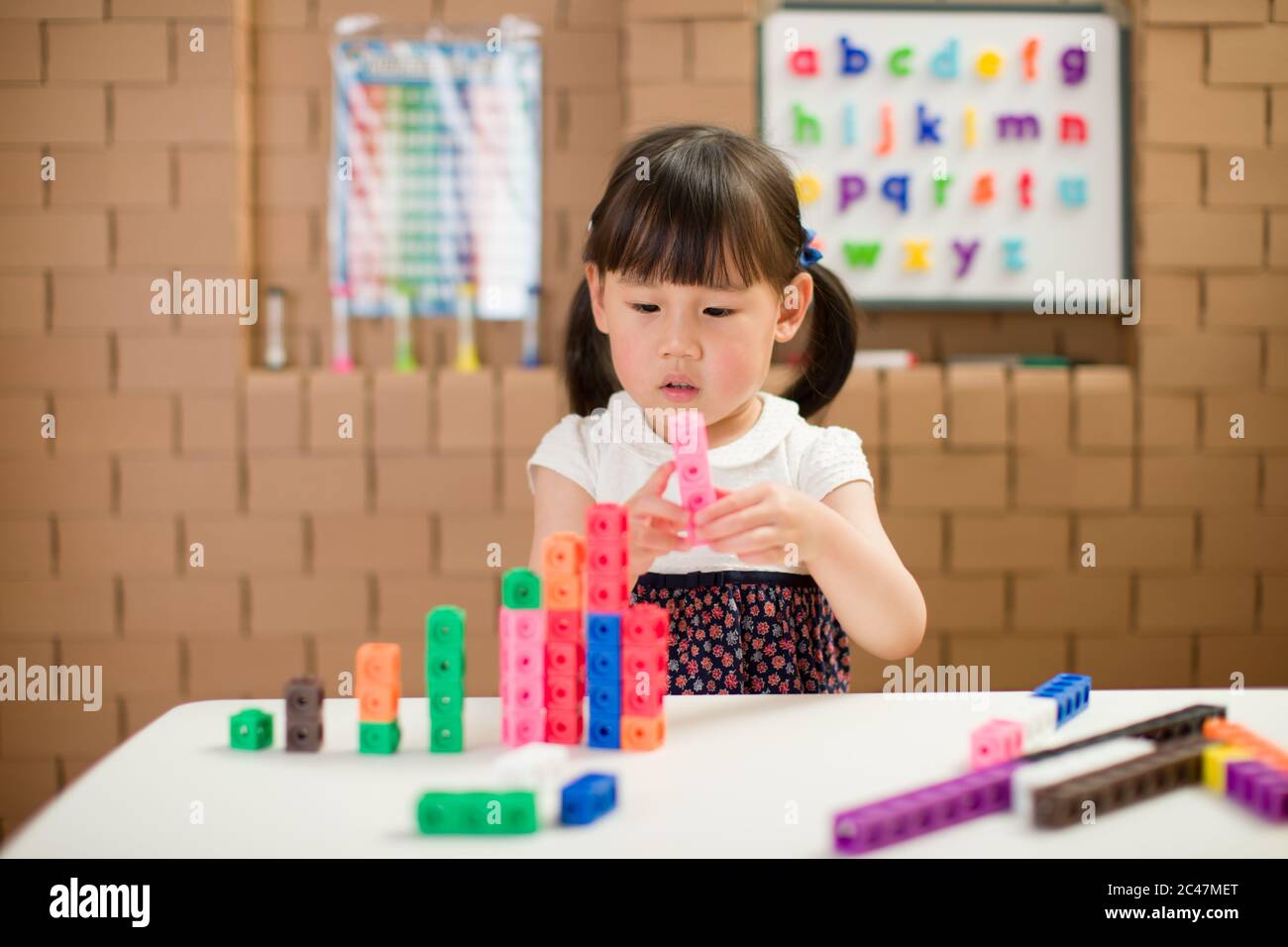 toddler girl play number blocks for homeschooling Stock Photo - Alamy