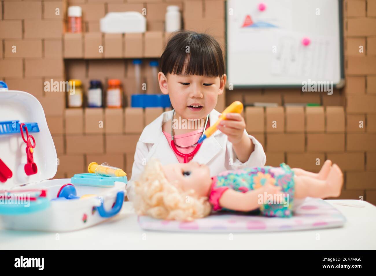 toddler girl pretend play doctor role at home Stock Photo - Alamy