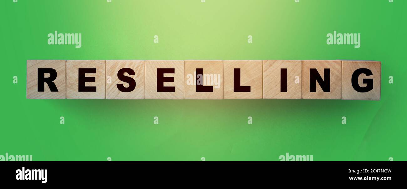 Resselling word wooden cubes on the green background. Business model ...