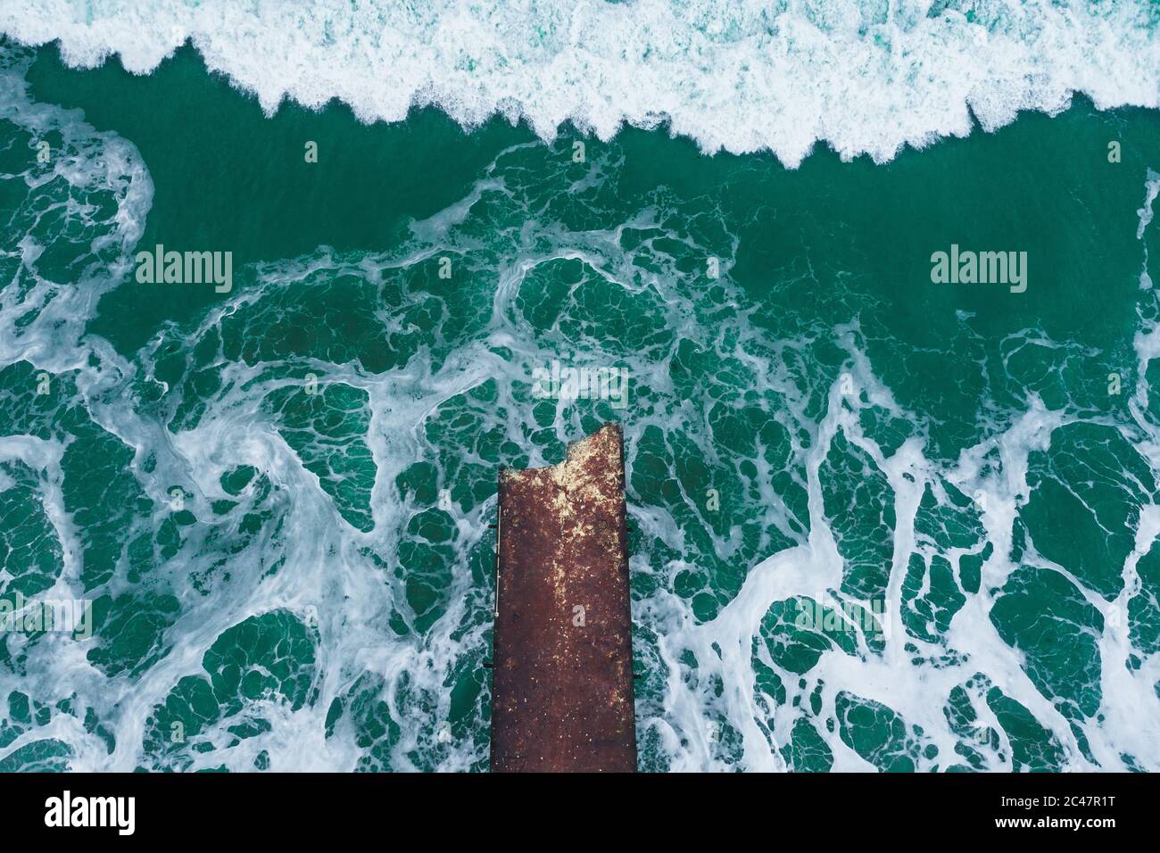 Texture of ocean wave and broken bridge Stock Photo - Alamy