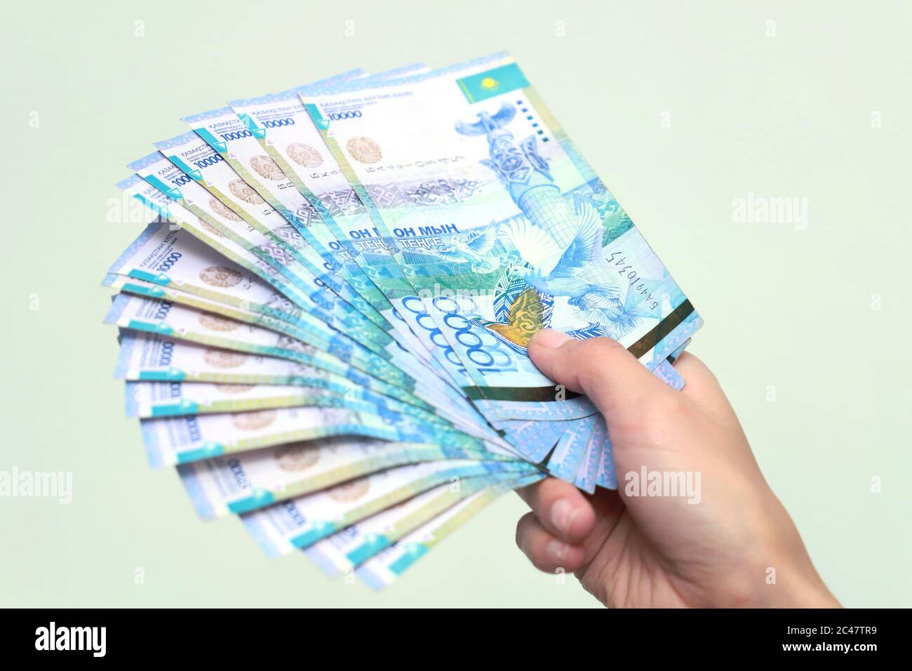 Tenge National currency of Kazakhstan in hand. Isolated on white ...