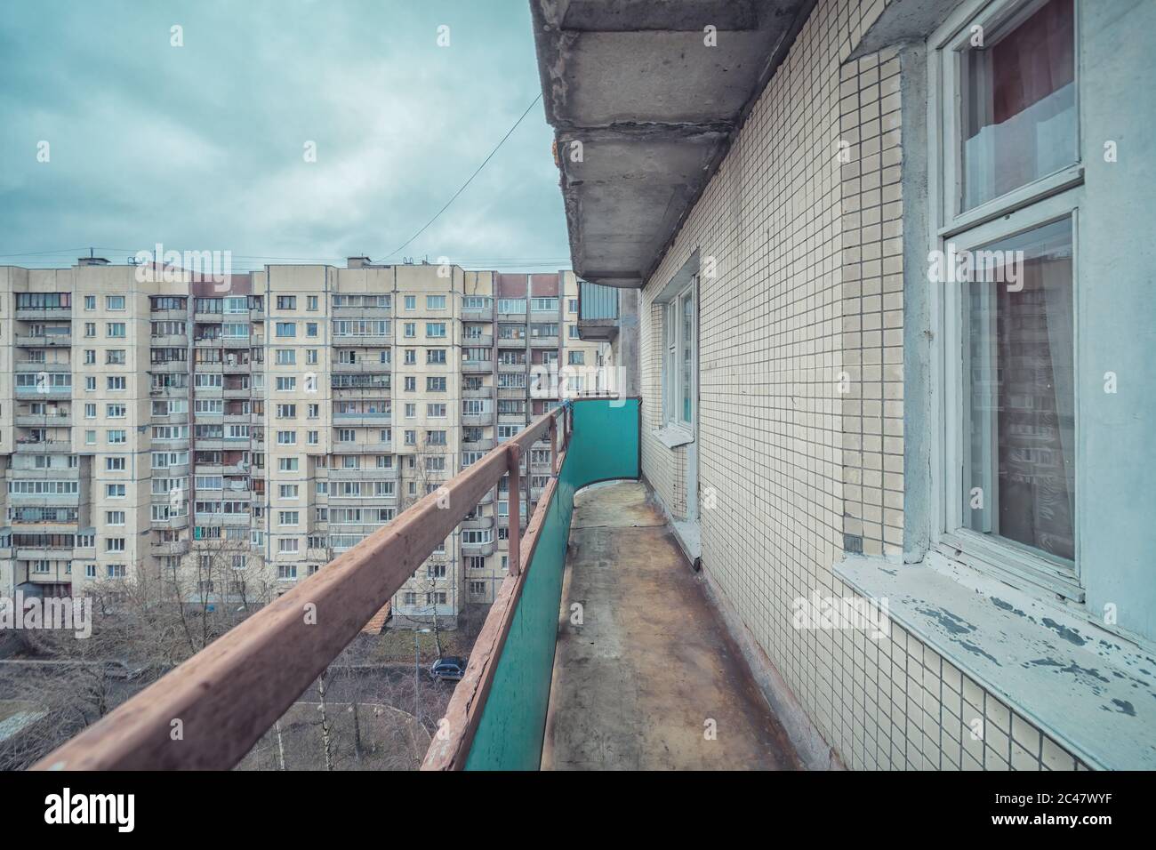 Old common open balcony in high residential apartment building maid of ...