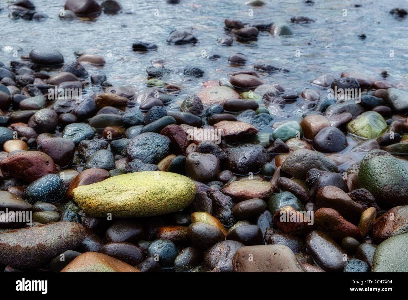 Lot of rocks in different sizes in the sea Stock Photo - Alamy
