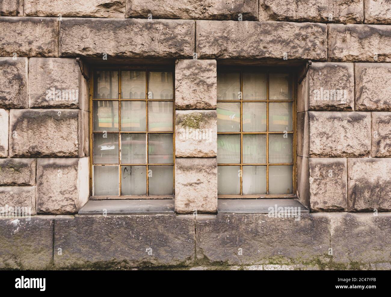 Windows on an old block wall Stock Photo - Alamy