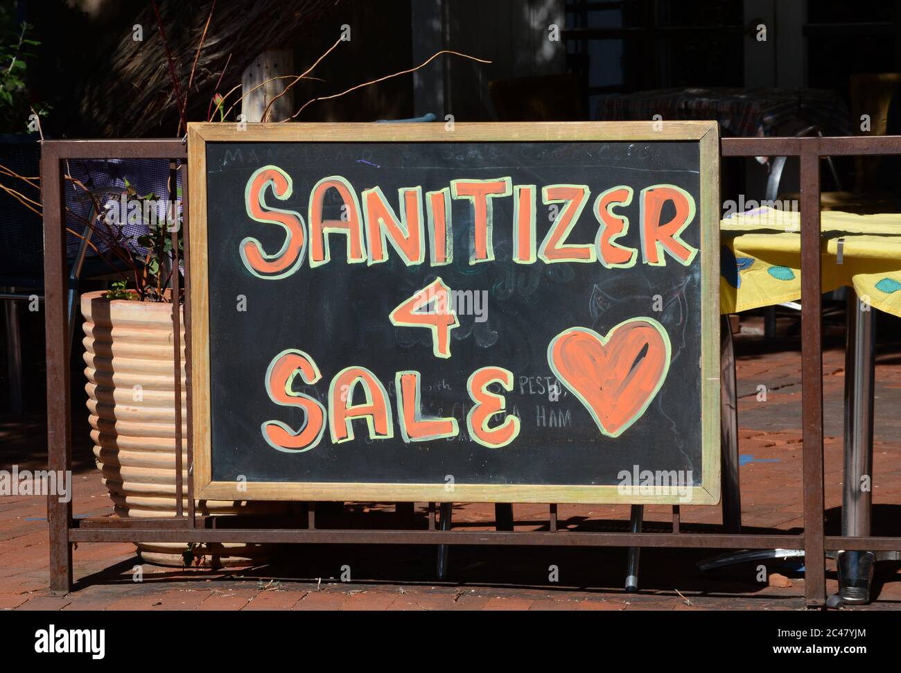 A sign outside a restaurant advertises that hand sanitizer is for sale ...
