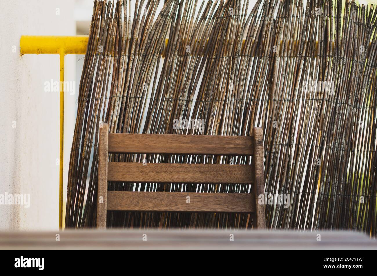 Old wooden chair on a fence background with wooden sticks Stock Photo ...