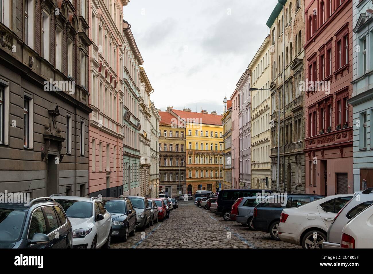 Colorful facades line a cobblestoned residential street in Prague ...