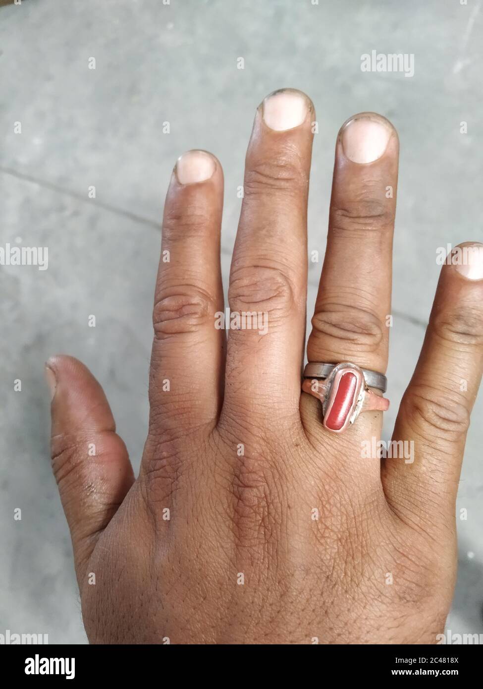 Closeup of a hand with two rings on the ring finger Stock Photo - Alamy