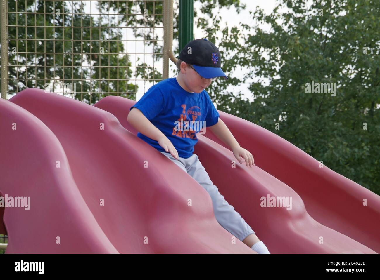 Happy boy going down slide hi-res stock photography and images - Alamy