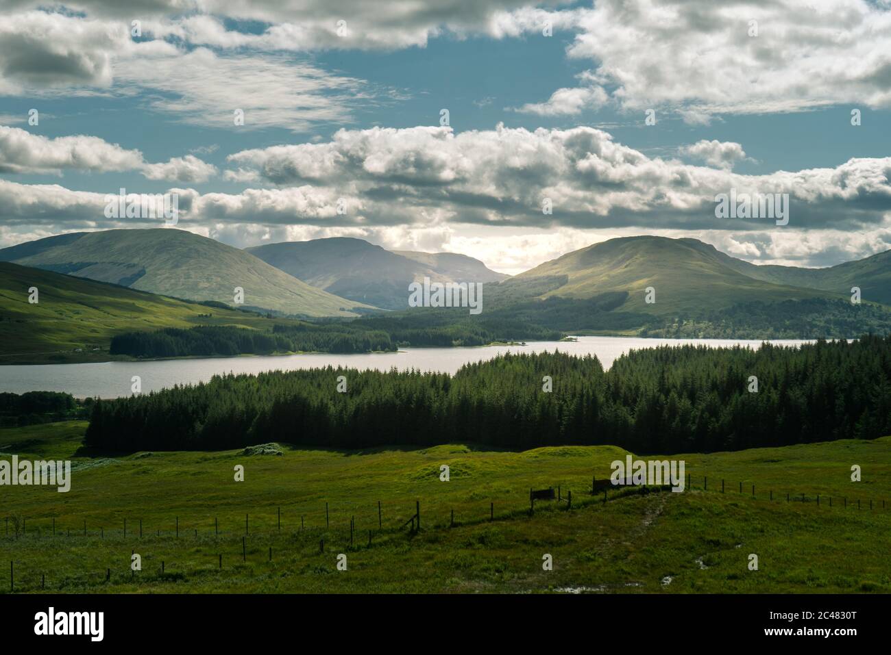 Lake Loch Tulla surrounded by mountains and meadows in the UK Stock ...
