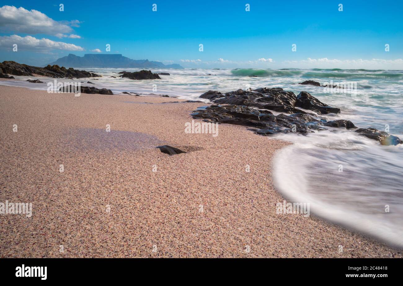 Beach surrounded by the sea with long exposure under the sunlight at ...