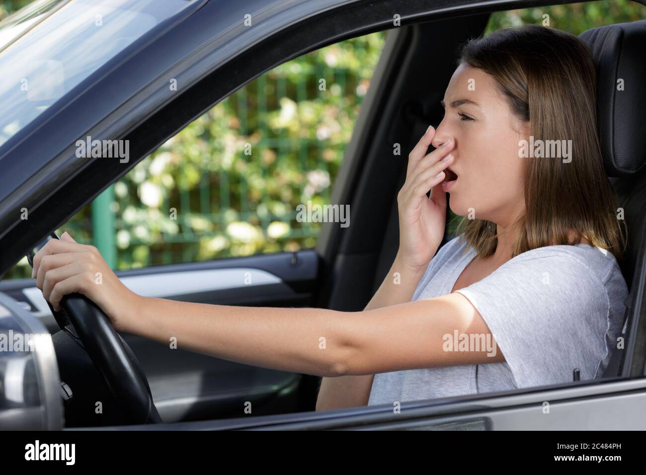 tired beautiful woman driver has sleepy expression Stock Photo - Alamy