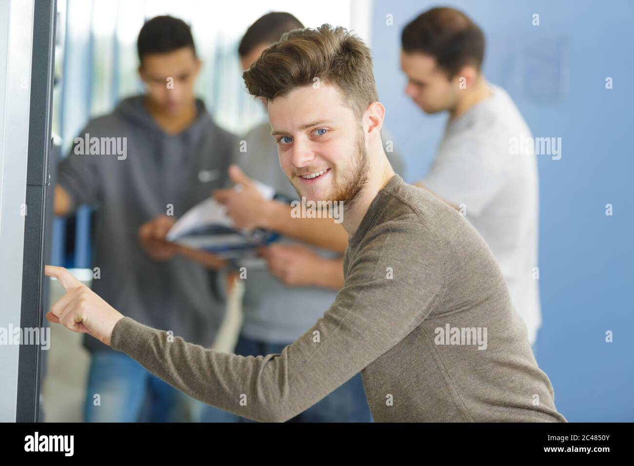 happy student next to lockers at the college Stock Photo - Alamy