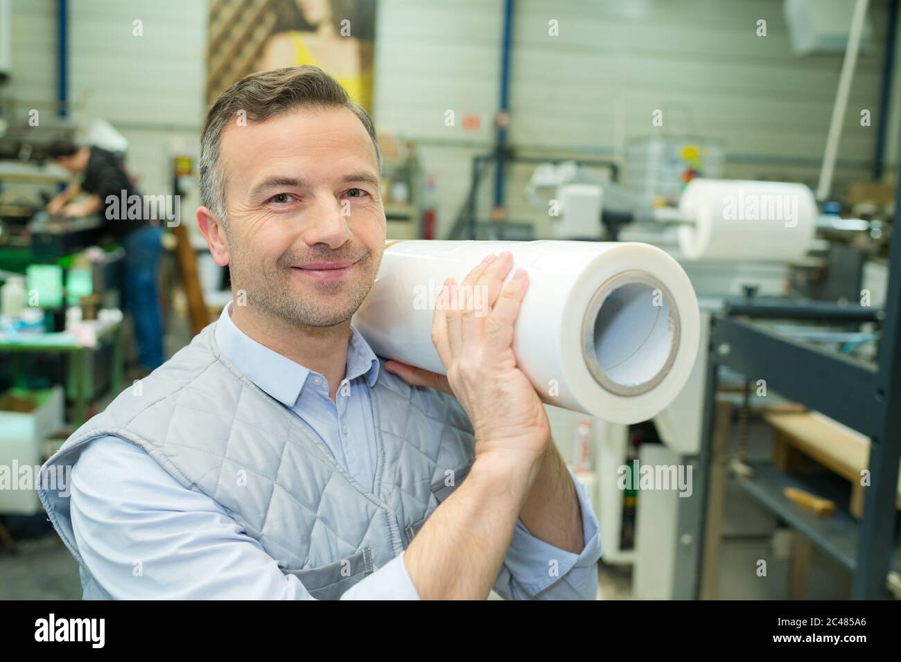 portrait of warehouse worker carrying paper Stock Photo - Alamy