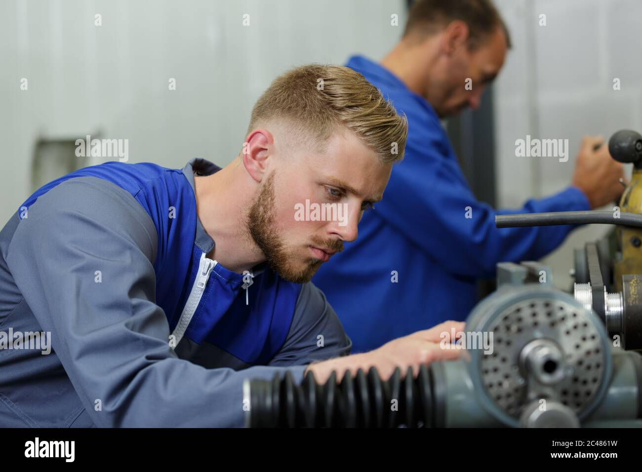a mechanic mending a motor Stock Photo - Alamy
