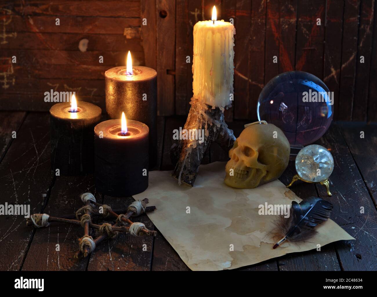 Black candles, skull and empty paper on witch table. Esoteric, wicca ...
