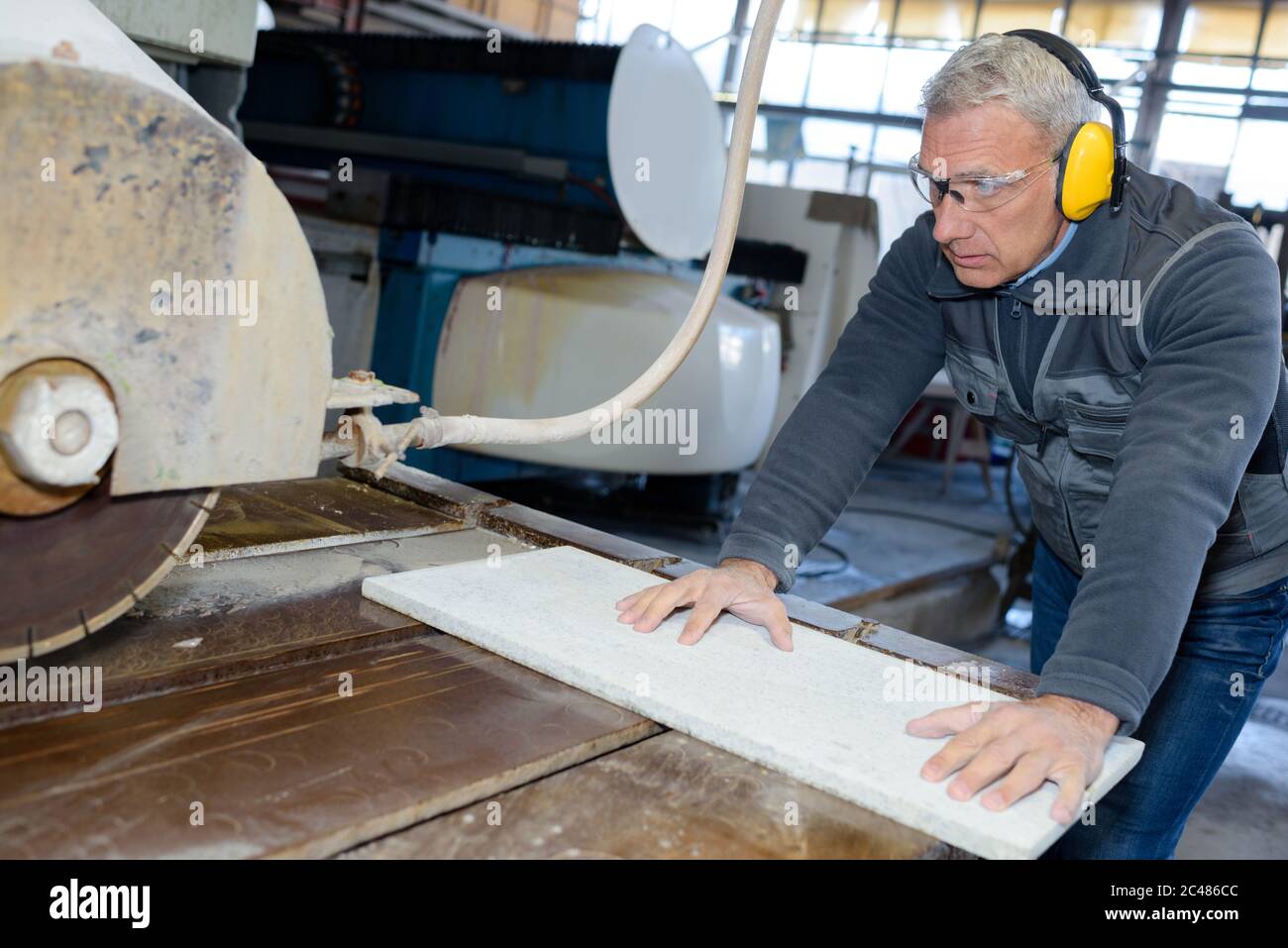 a worker and marble cutting worker Stock Photo - Alamy