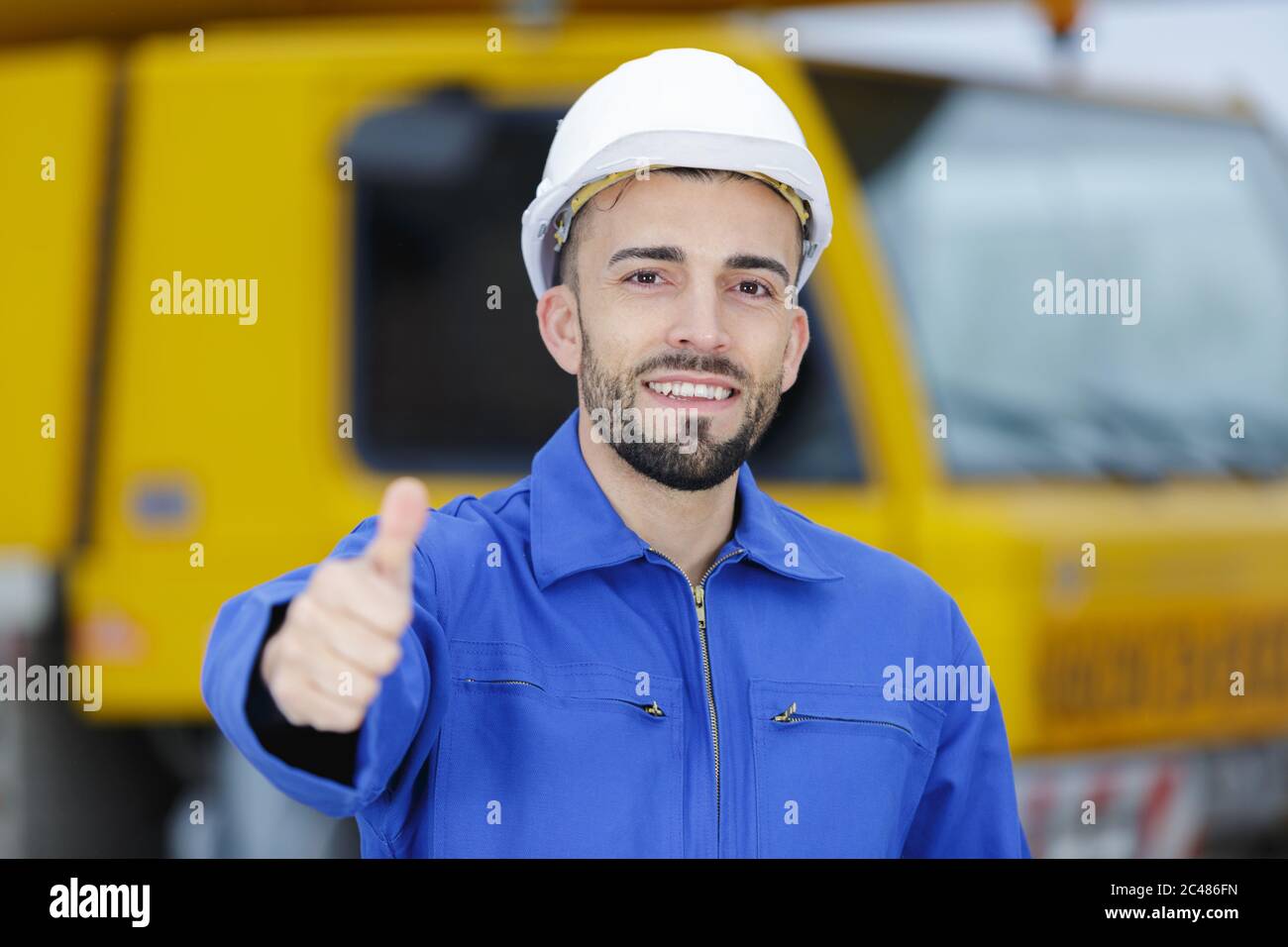happy worker smiling sowing thumbs up Stock Photo - Alamy