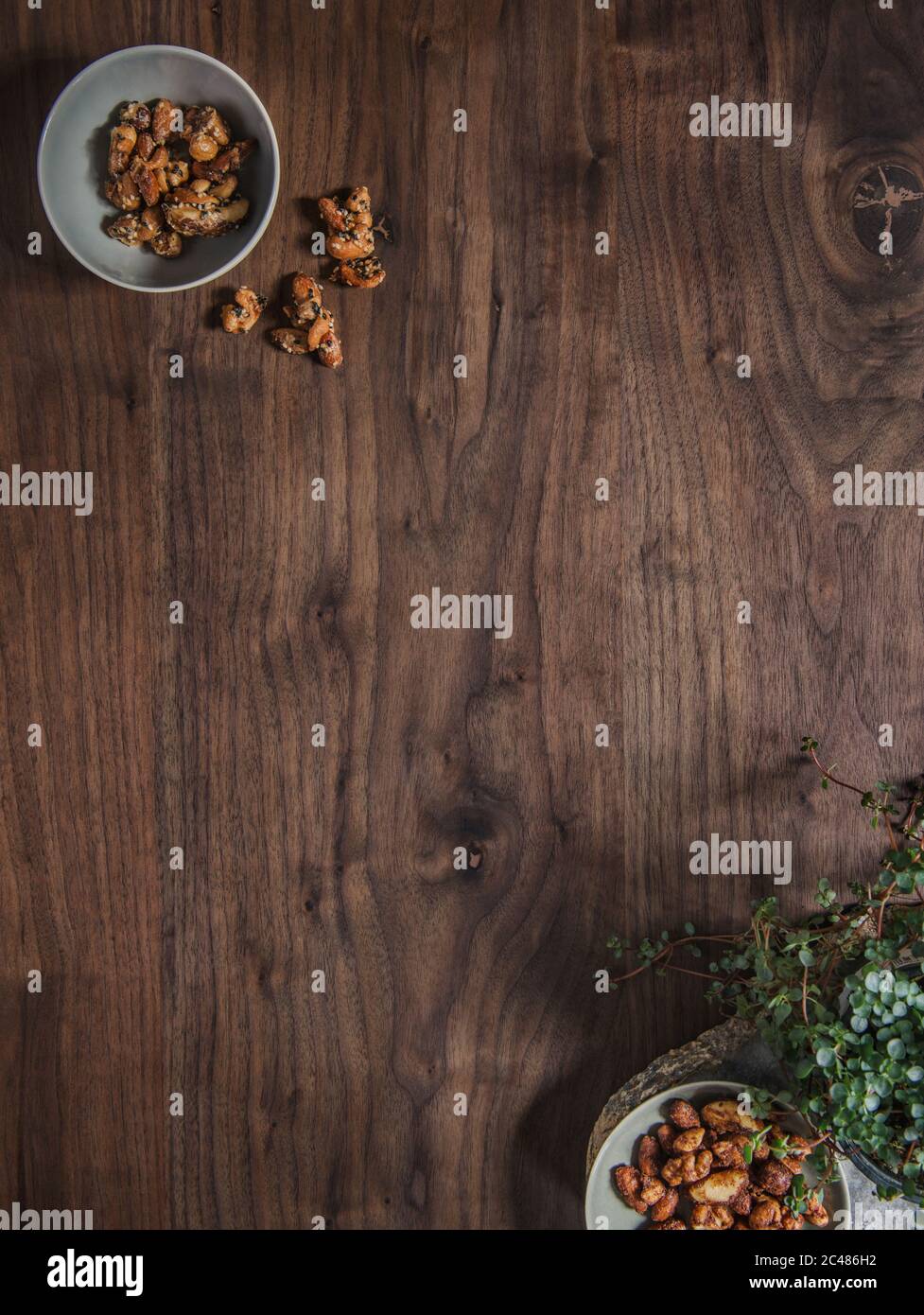 Wooden table with mixed nuts Stock Photo - Alamy
