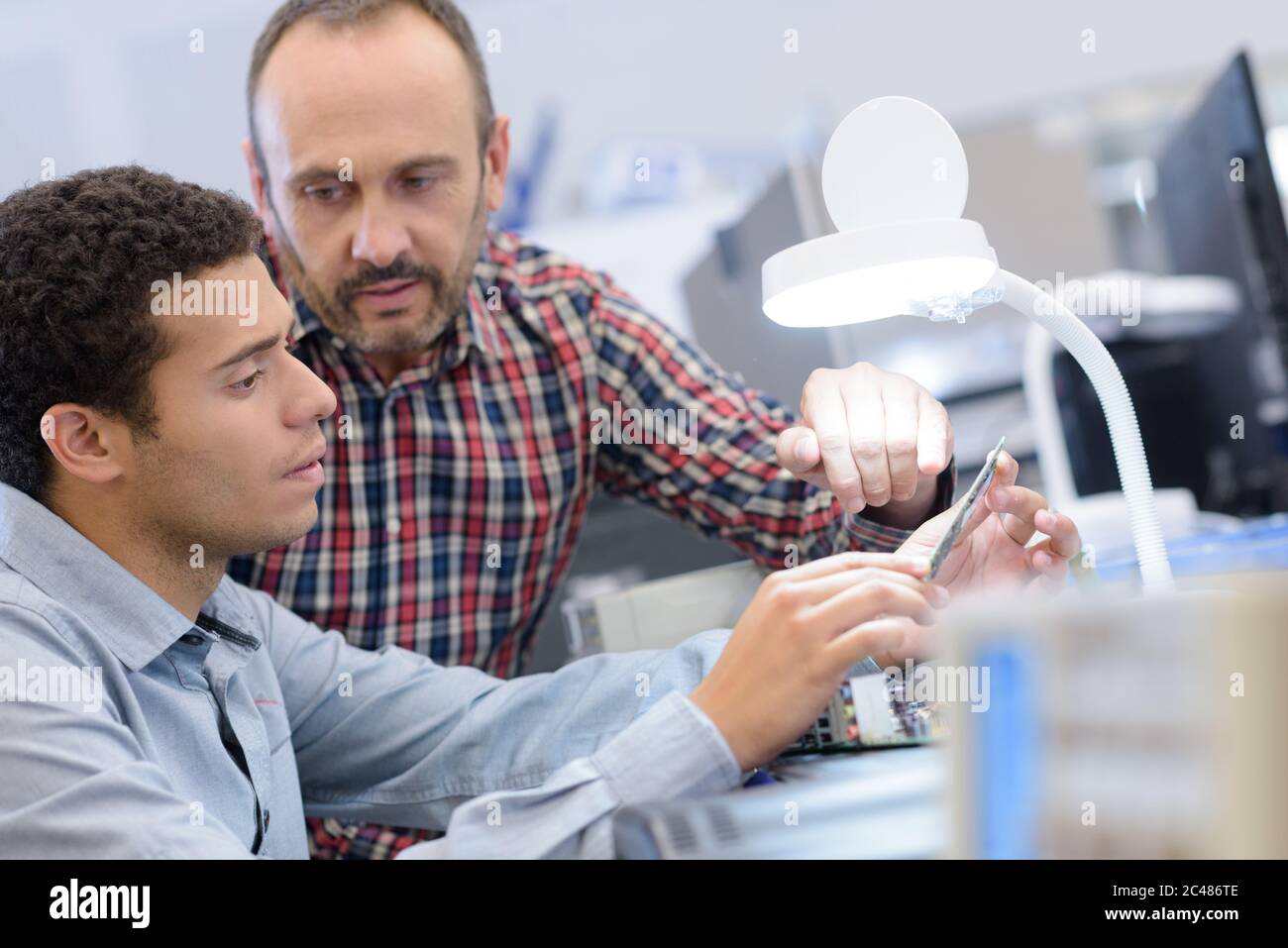 teacher with students in apprenticeship attending computing class Stock ...