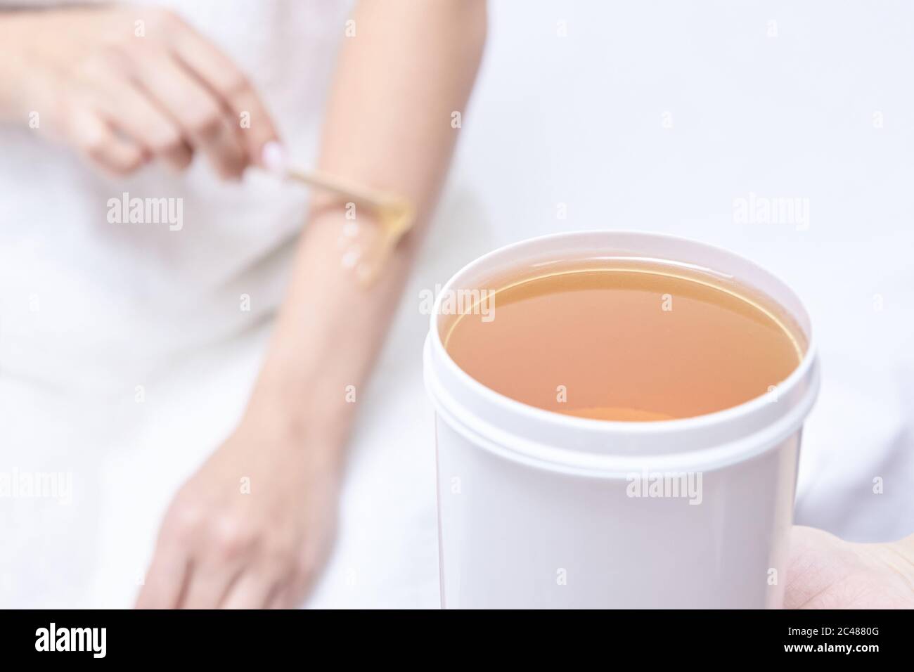 Beautiful girl forearm waxing procedure. Remove hair at home self sugar ...