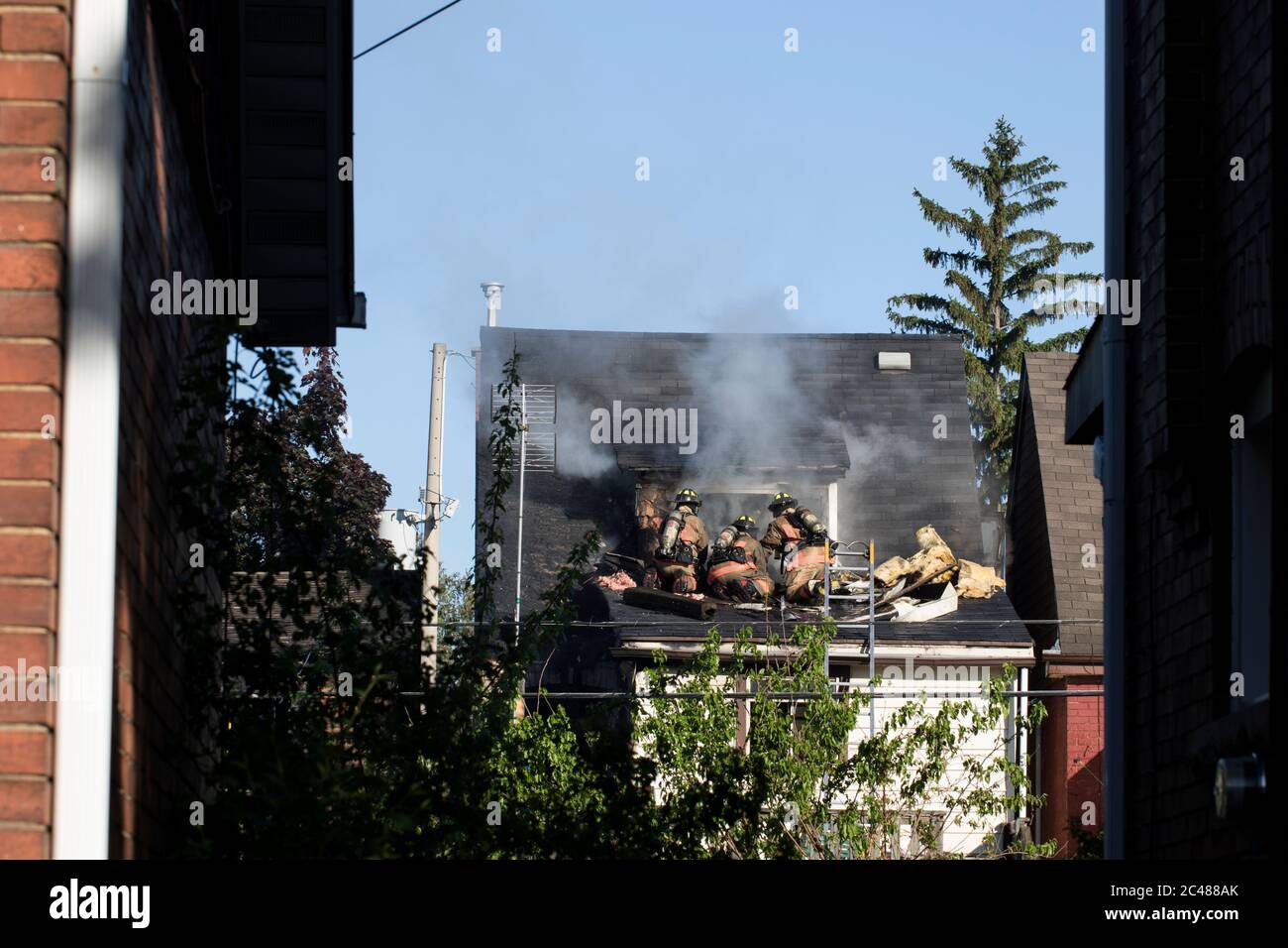 Smoke from house fire billowing in the air during the day time. Heavy ...