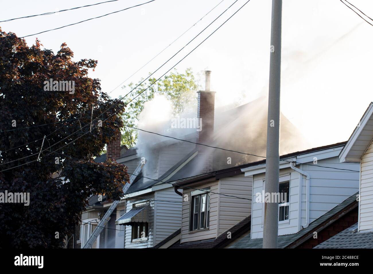 Multiple alarm fire smoke rising from houses. Two homes caught on fire ...