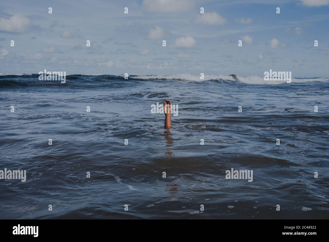 Amazing shot of a human hand sinking in a sea- perfect for people ...