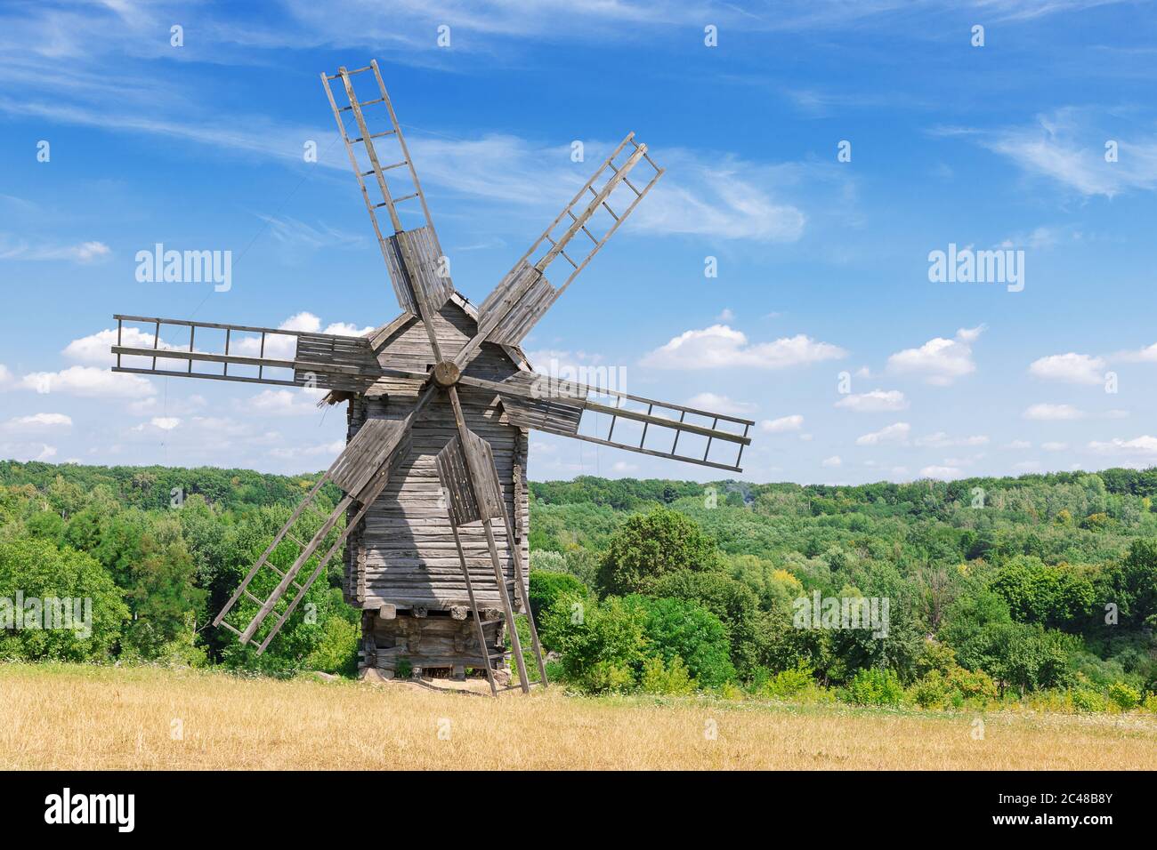 Old Rare Ancient Wooden Windmill in front of Blue Cloud Sky Stock Photo ...