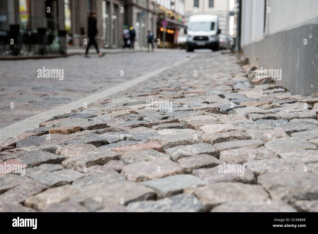 Paved street, carriageway and pedestrian sidewalk. In the old town ...
