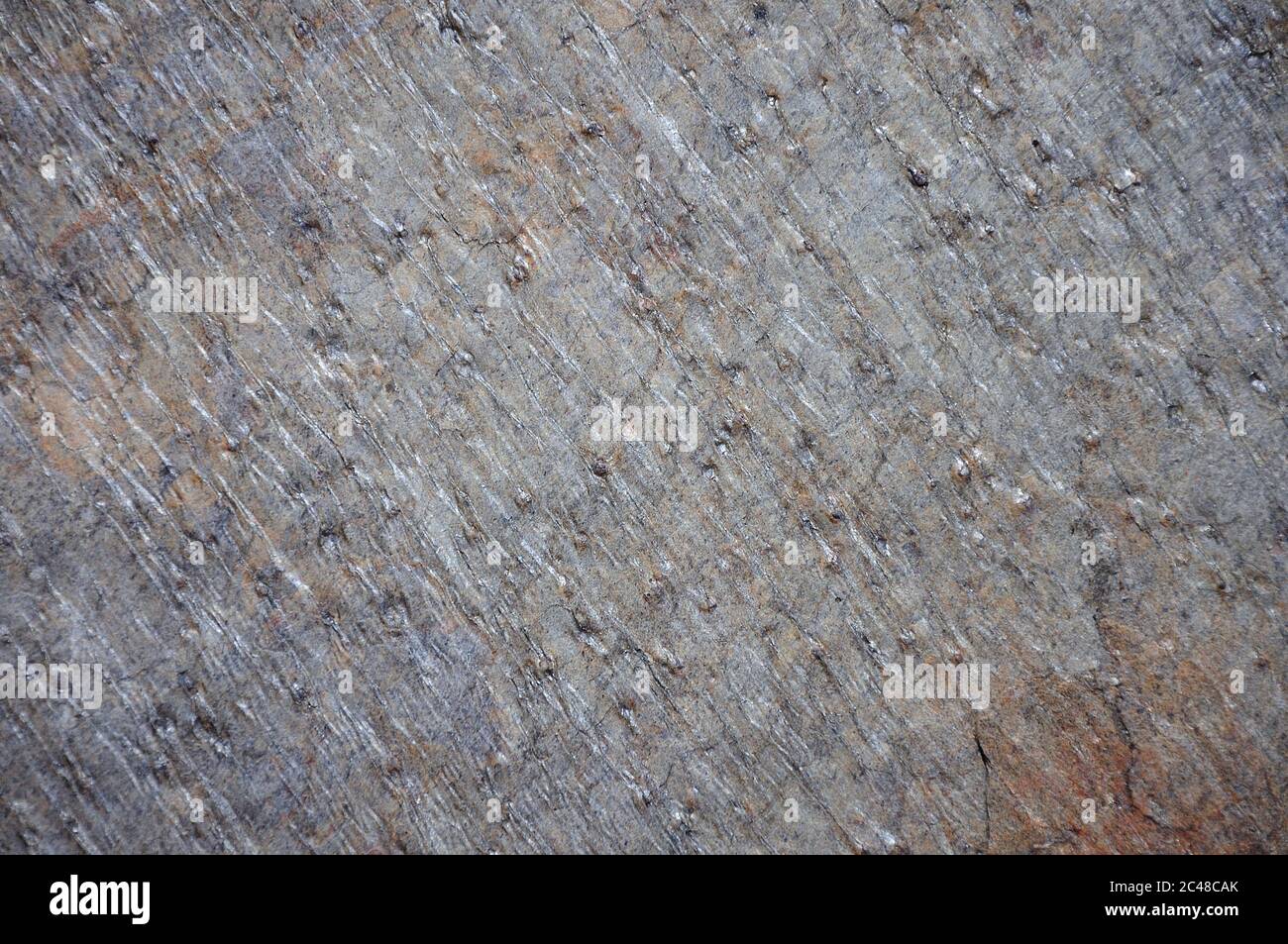 Rough surface of natural gray stone with traces of rough processing ...