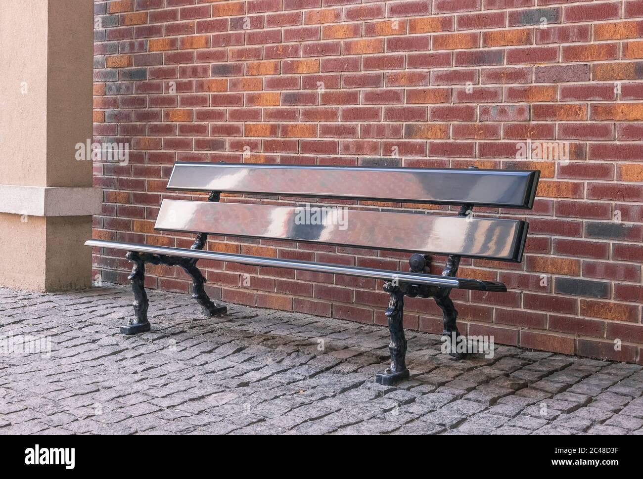 Vintage Style Empty Bench on the Pave Street in front of Red Brick Wall ...