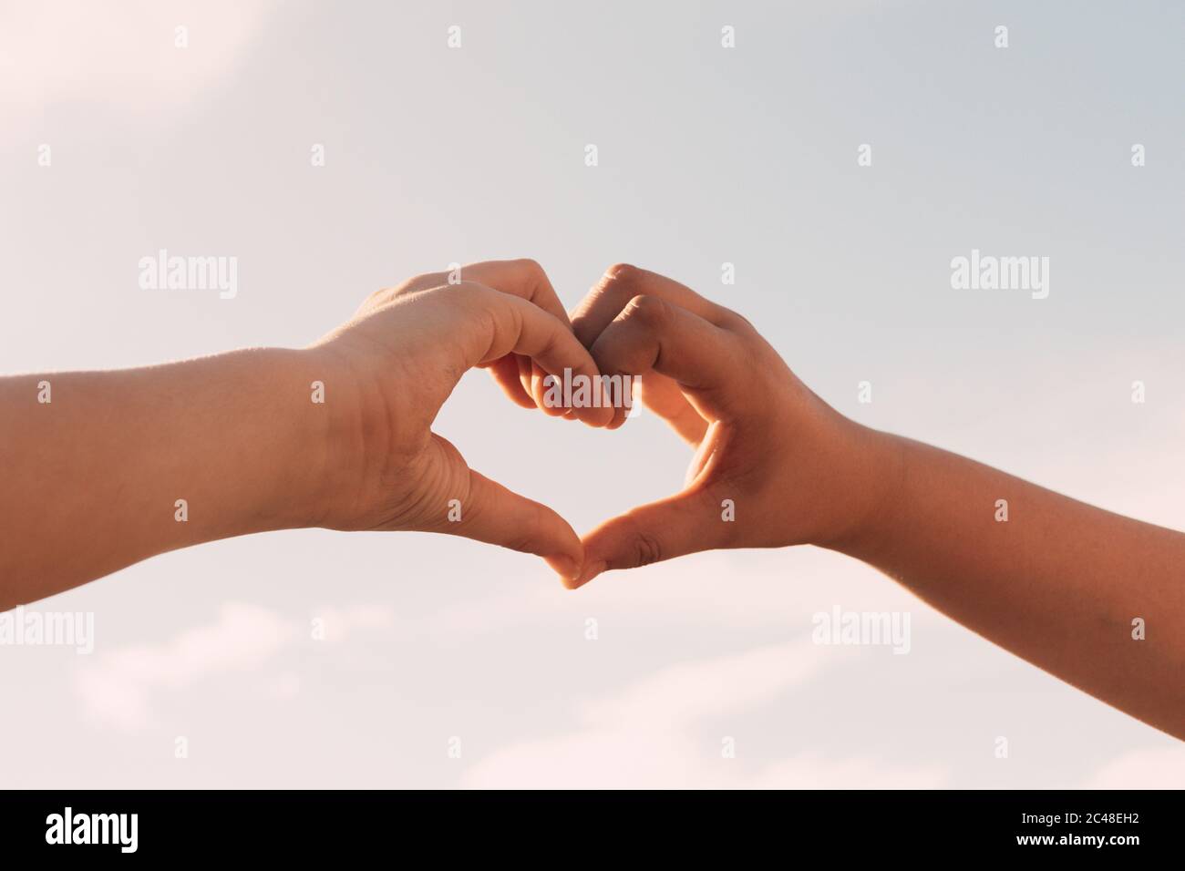 Two People Making A Heart With Their Hands