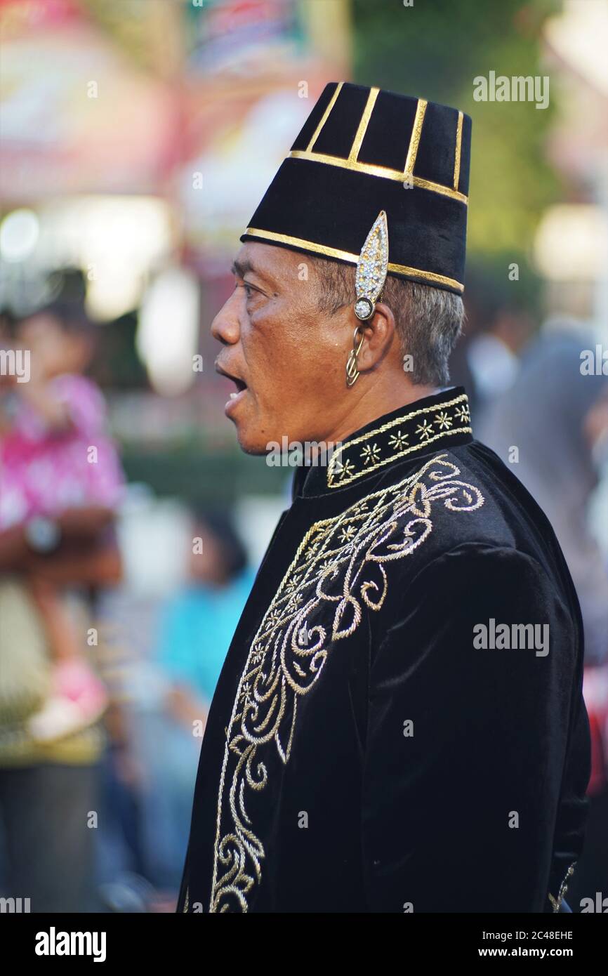 A man wears the traditional clothing of the Yogyakarta palace in a ...