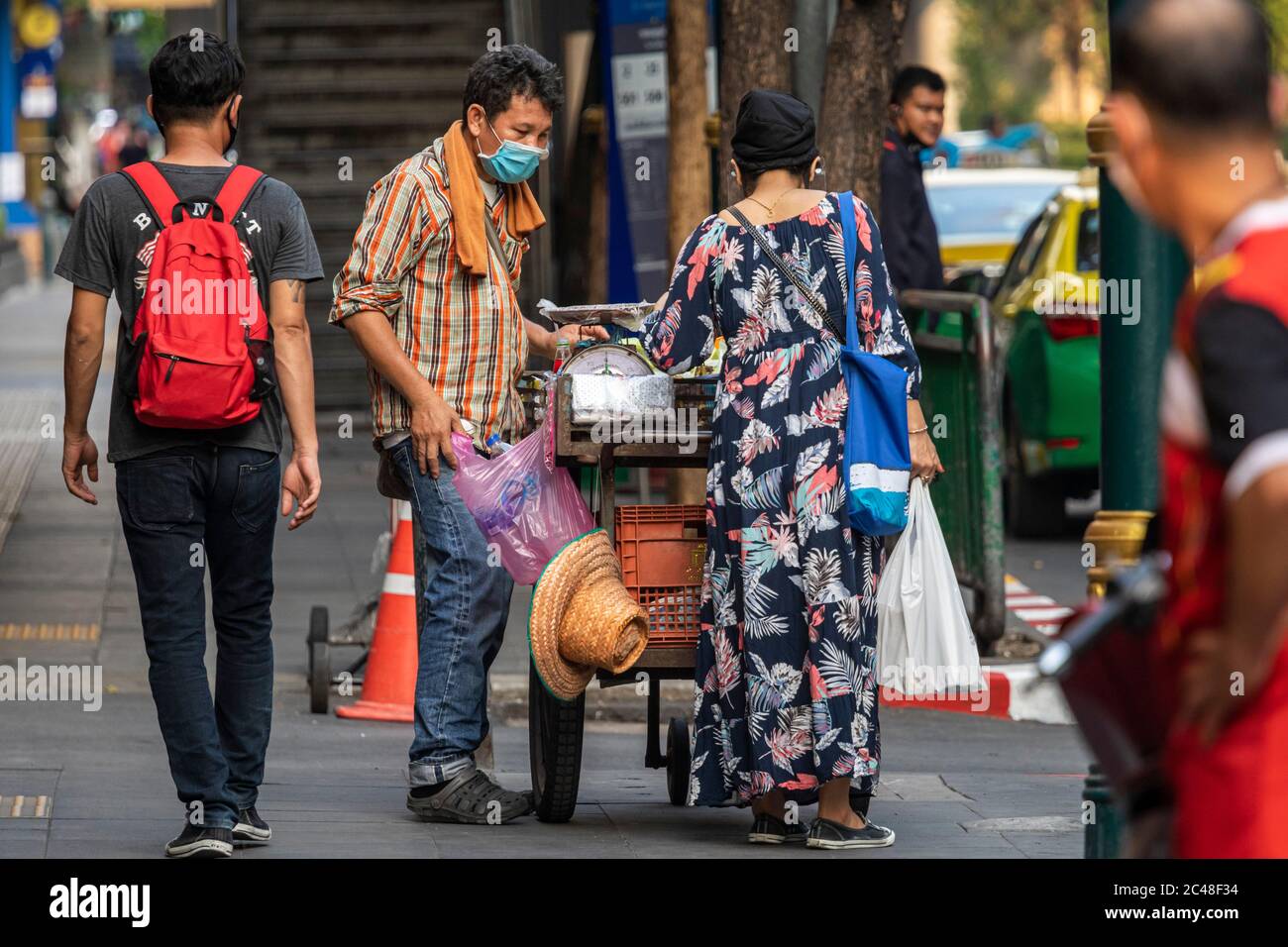 Food vendor and customer wearing face mask during Covid 19 pandemic ...