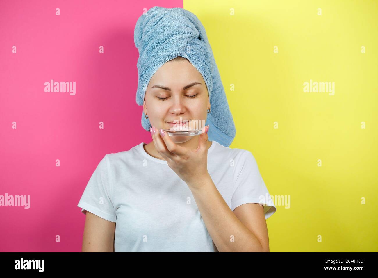 Portrait of a beautiful young girl who puts a refreshing mask on her ...